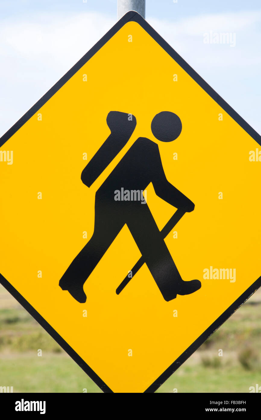 Yellow Hiking Sign with Rural Background Stock Photo - Alamy