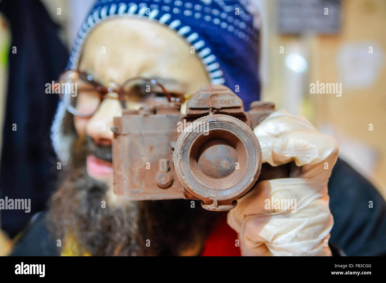 A market stall holder holds up an SLR camera made entirely from ...