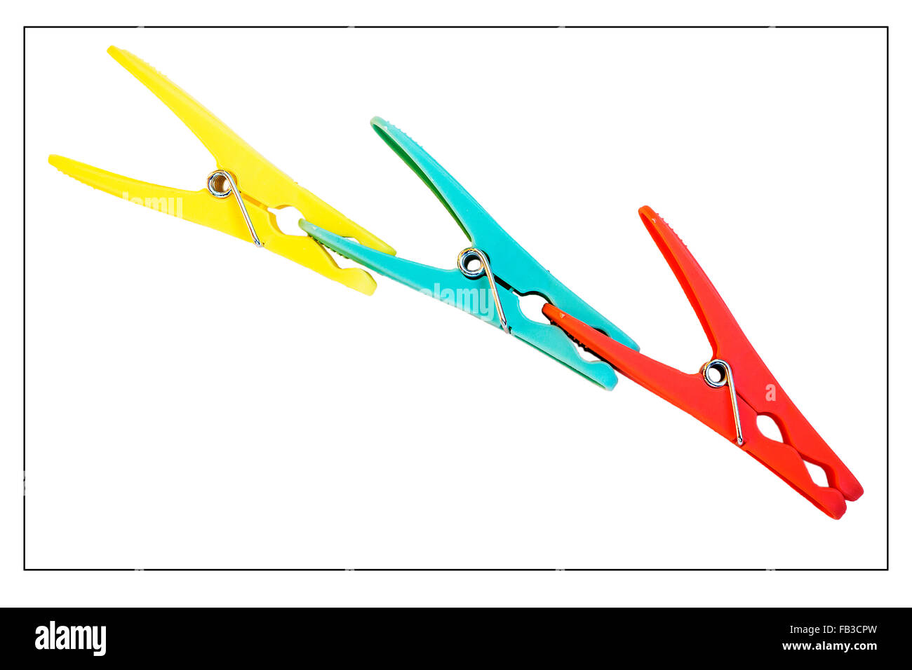 Three coloured pegs clipped together against a white background Stock ...
