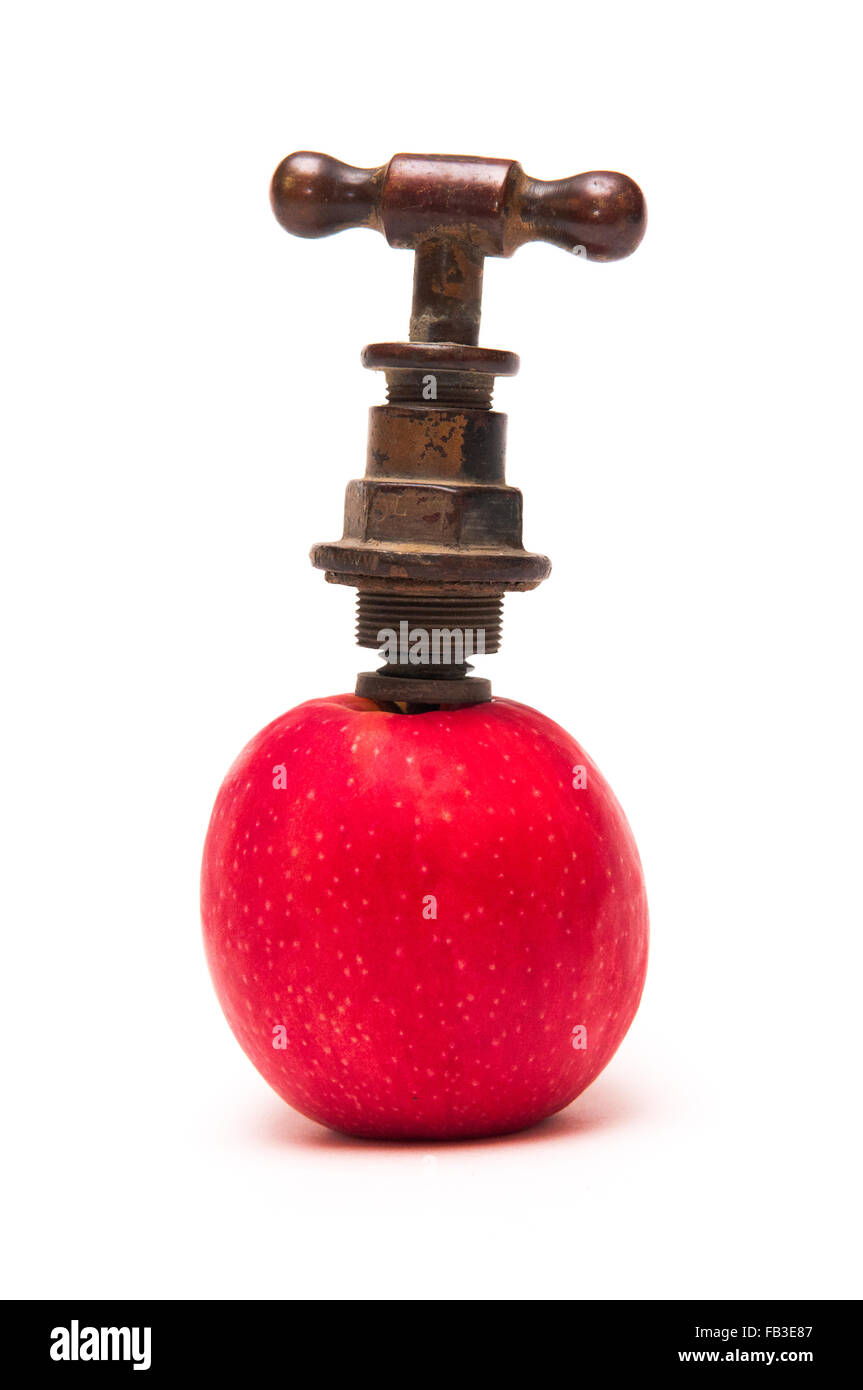 Old style tap in an apple Stock Photo - Alamy