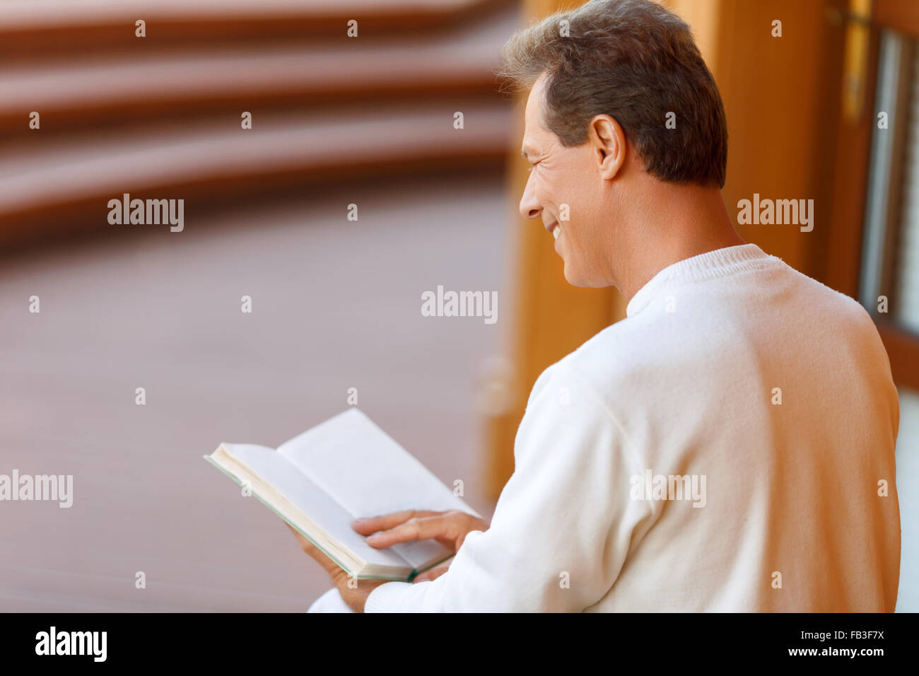 Nice man reading book Stock Photo - Alamy