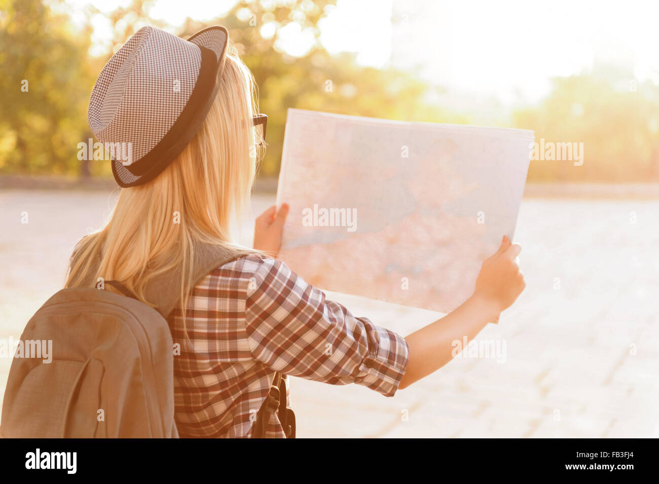 Cheerful girl holding map Stock Photo - Alamy