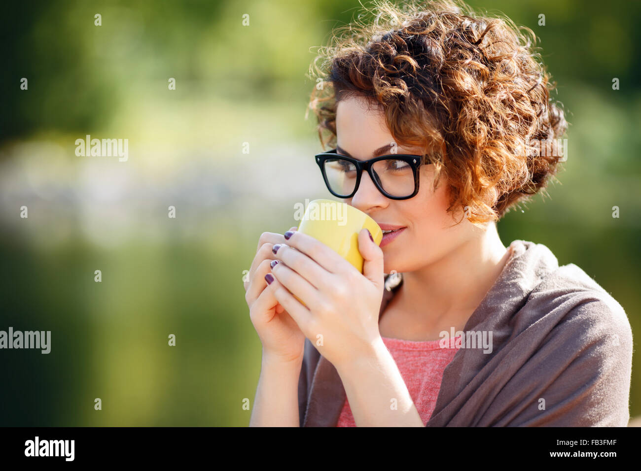 Charming girl drinking tea Stock Photo - Alamy