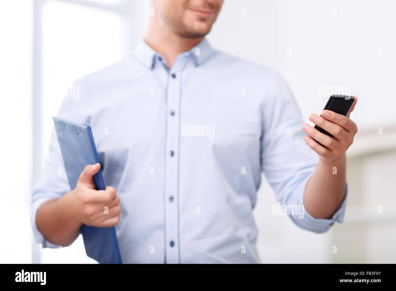 Professional realtor holding folder Stock Photo - Alamy