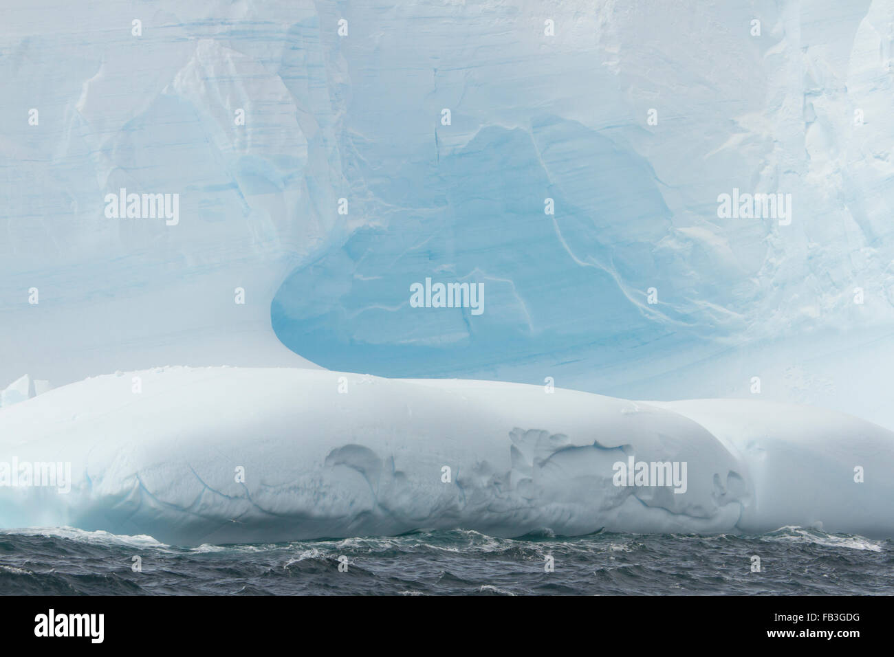 Erosion cavern on blue glacial iceberg in Antarctica Stock Photo - Alamy