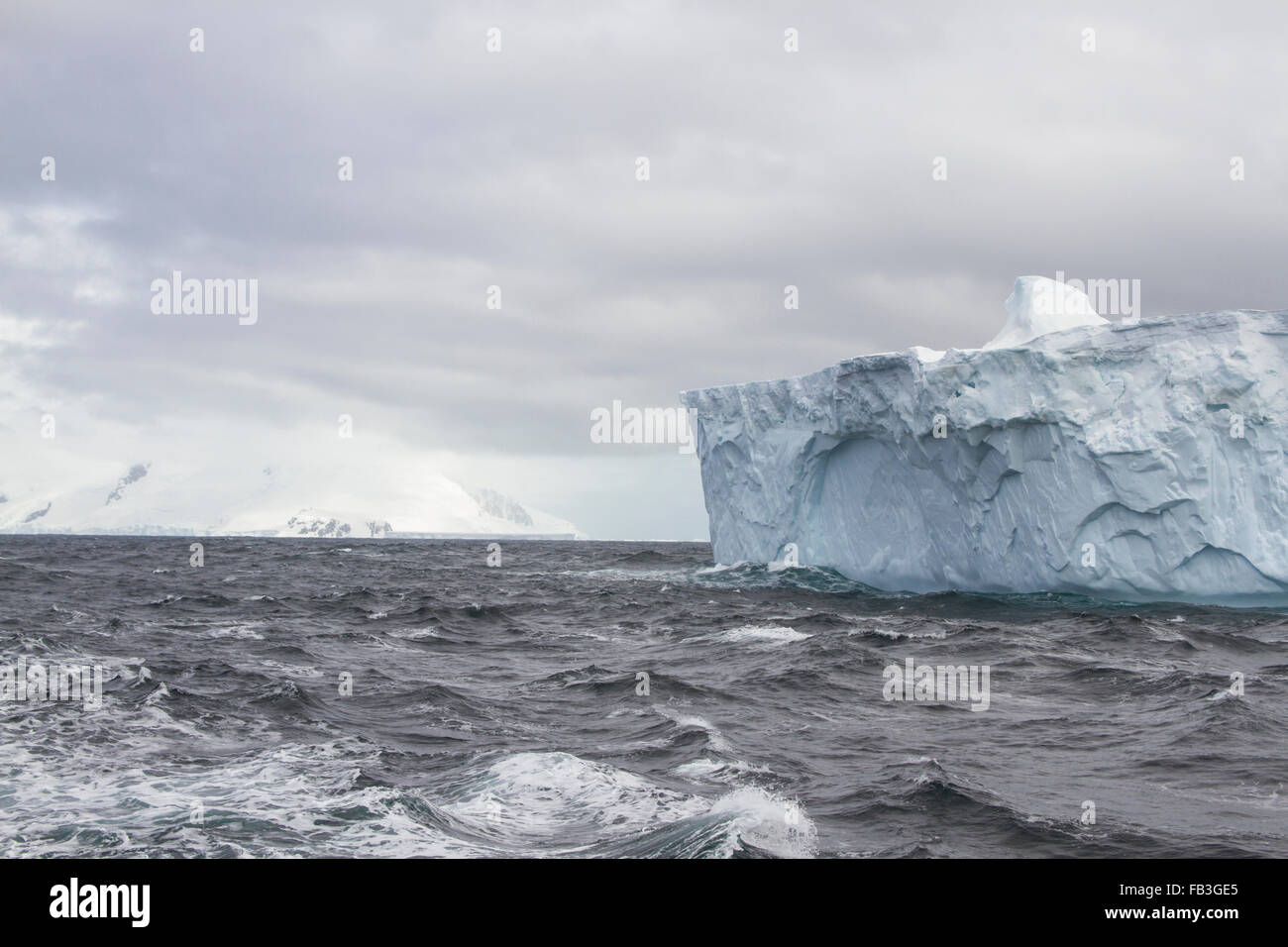 Shelf ice iceberg floating in rough seas near Snow Island in Antarctica ...