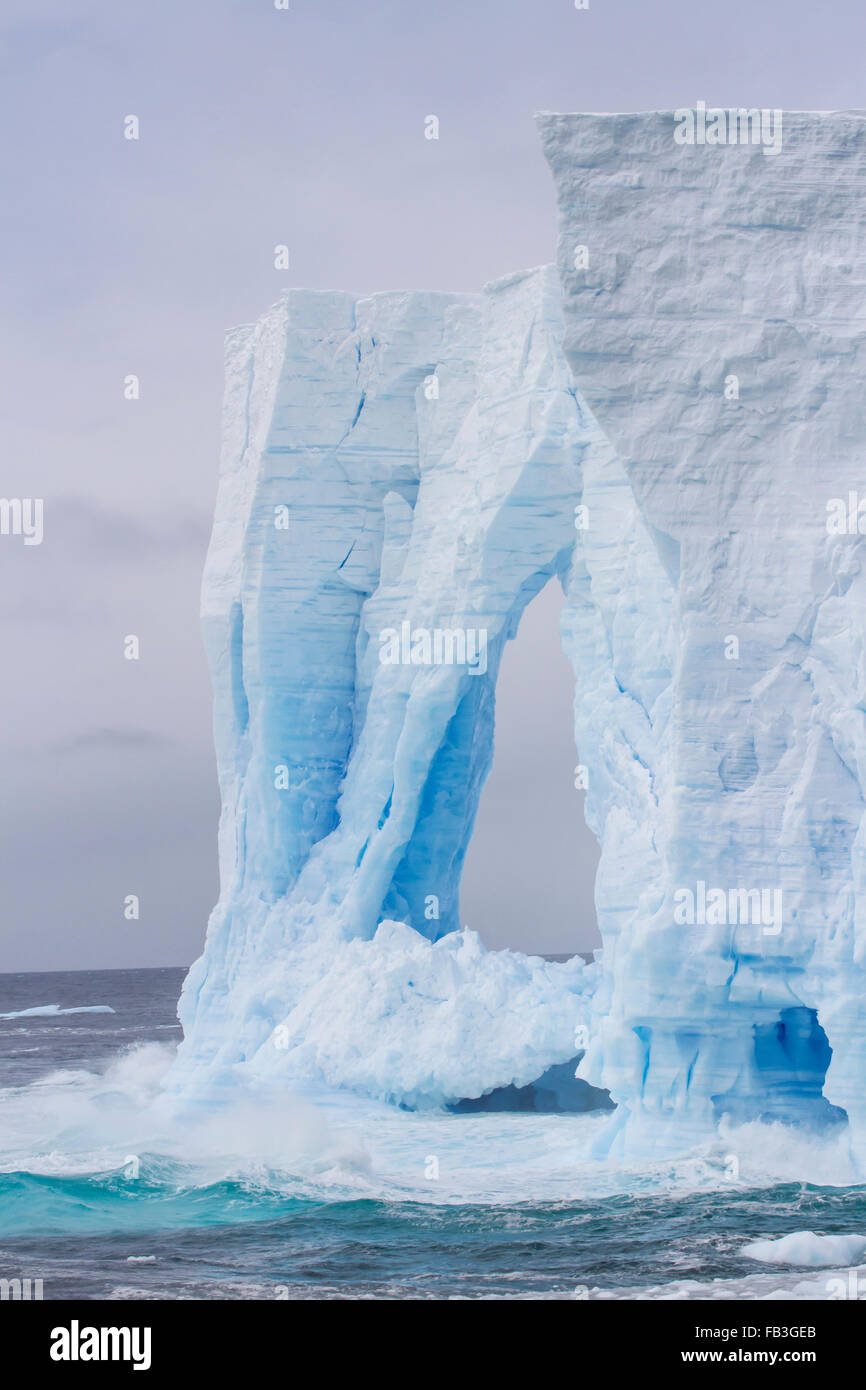 Tower formation with arches formed in glacial tabular iceberg in ...