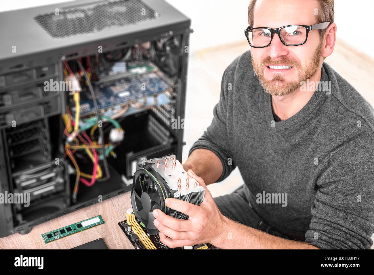 Computer technician installs cooling system Stock Photo - Alamy