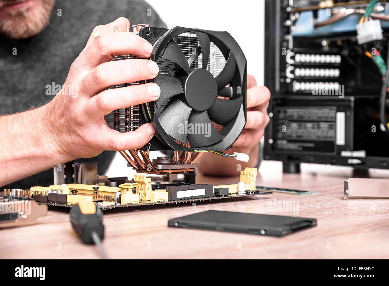 Computer technician installs cooling system Stock Photo - Alamy