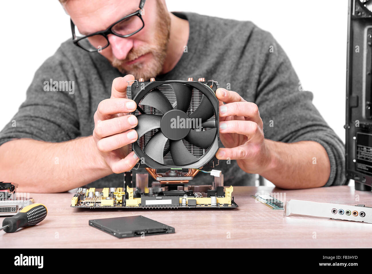 Computer technician installs cooling system Stock Photo - Alamy