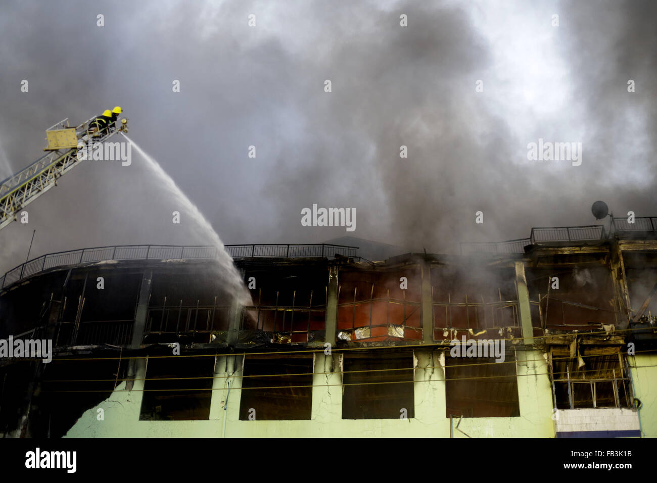 Yangon, Myanmar. 9th Jan, 2016. A fire fighter puts out fire at ...