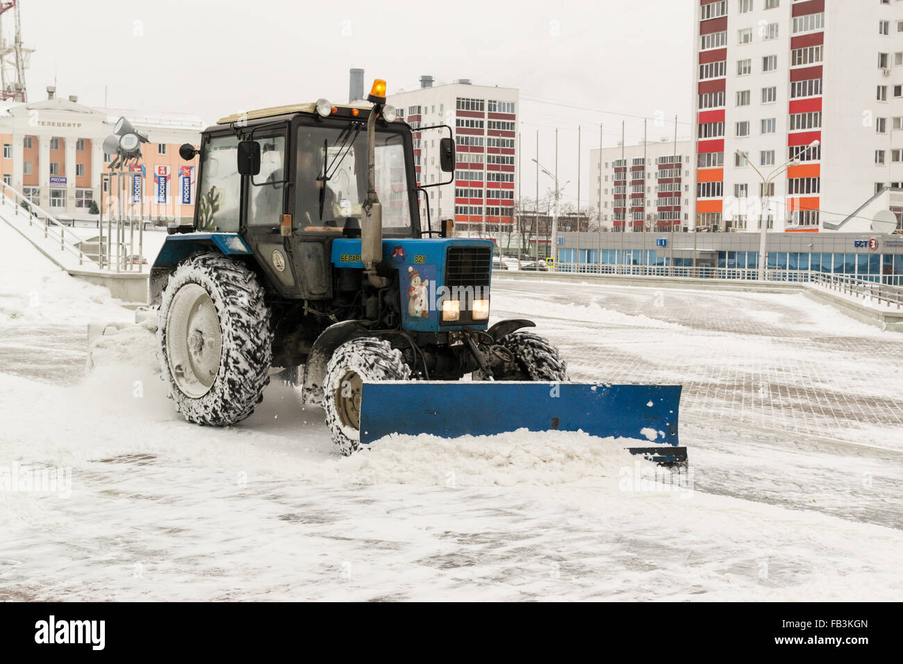 UFA - RUSSIA 27TH DECEMBER 2015 - Blue tractor uses a front shovel and ...