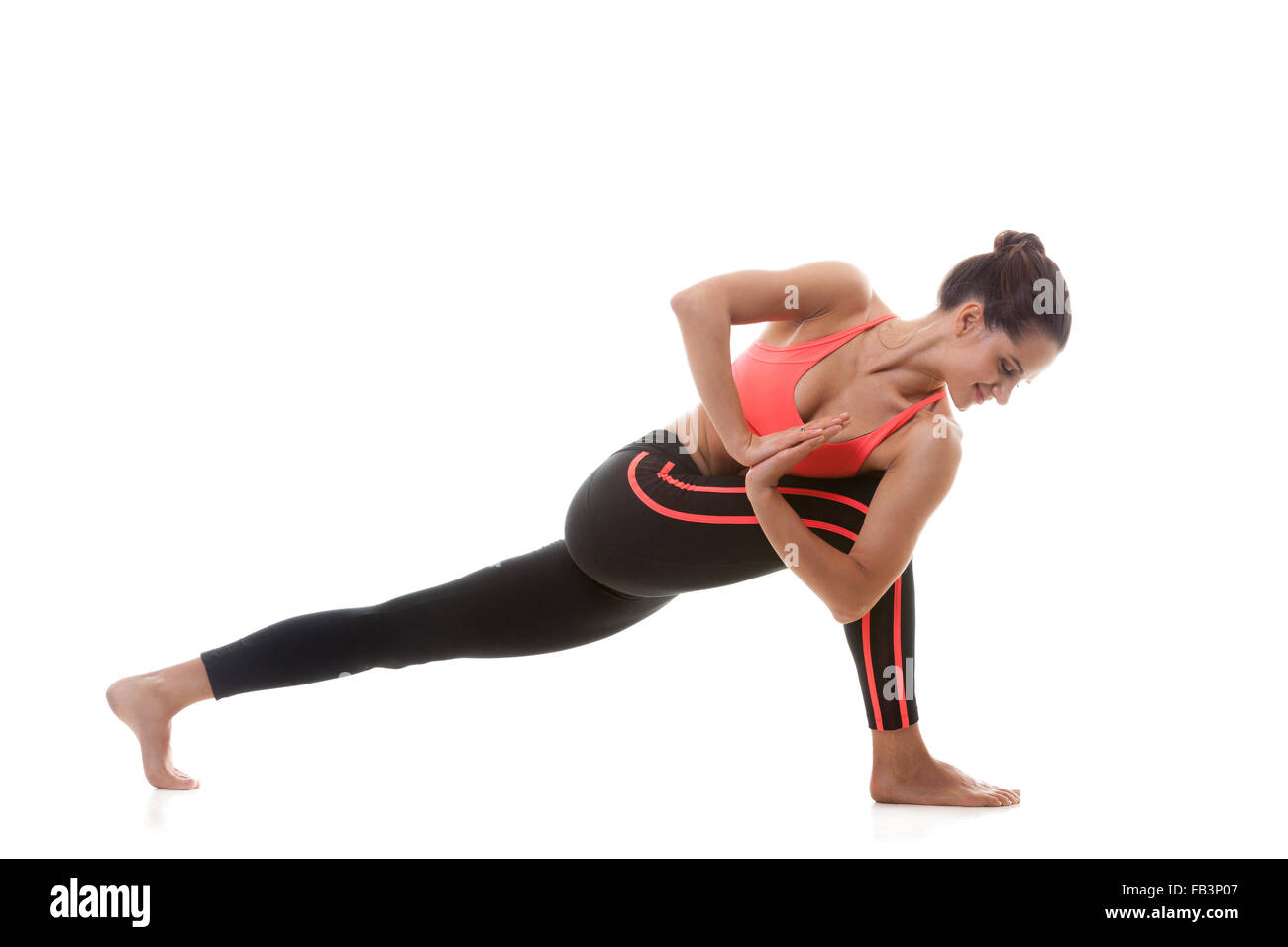 Sporty yoga girl on white background stepping back with one foot ...