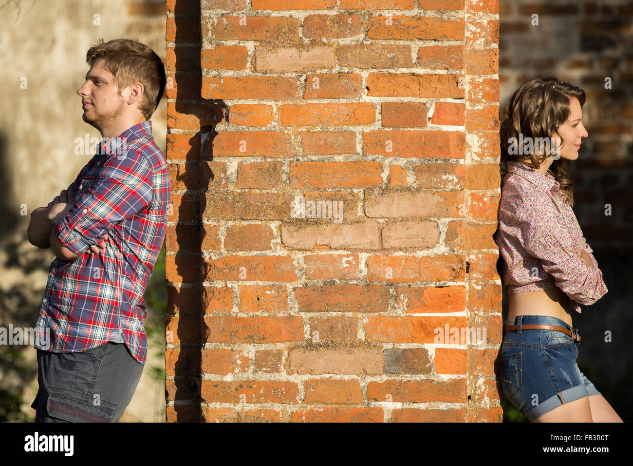 Couple after an argument stands on different sides of the wall Stock ...