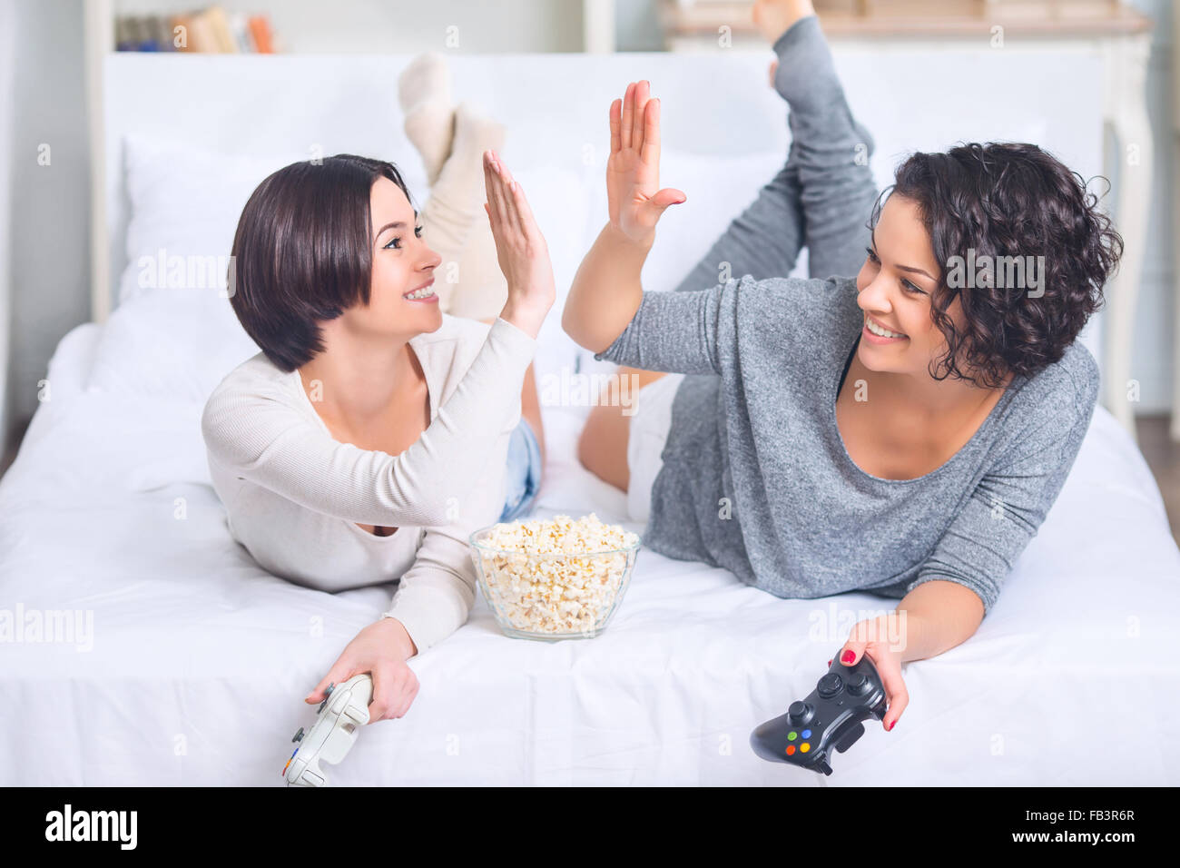 Sisters are high fiving in joy Stock Photo - Alamy