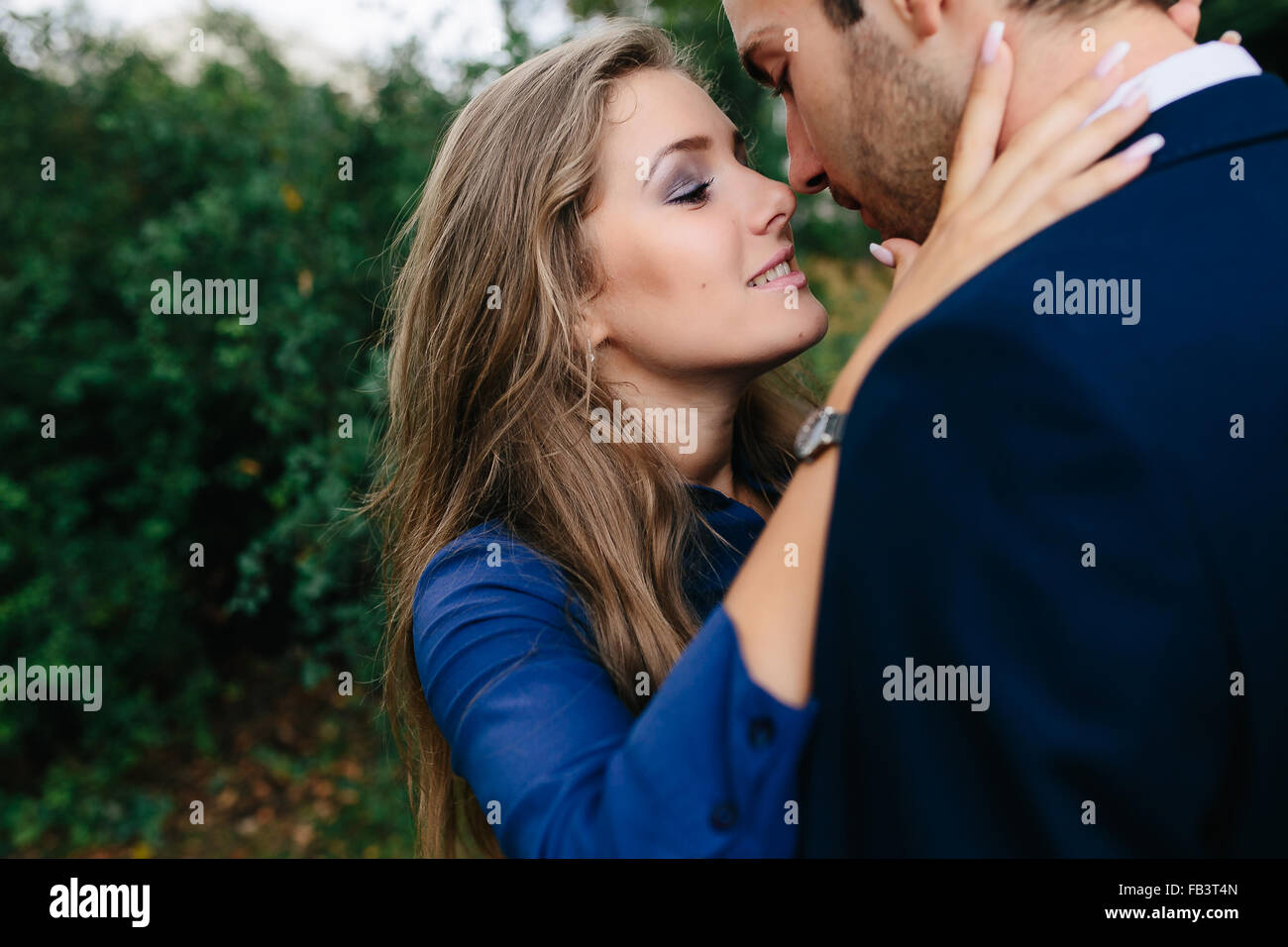 beautiful couple in each other's arms posing in city Stock Photo - Alamy