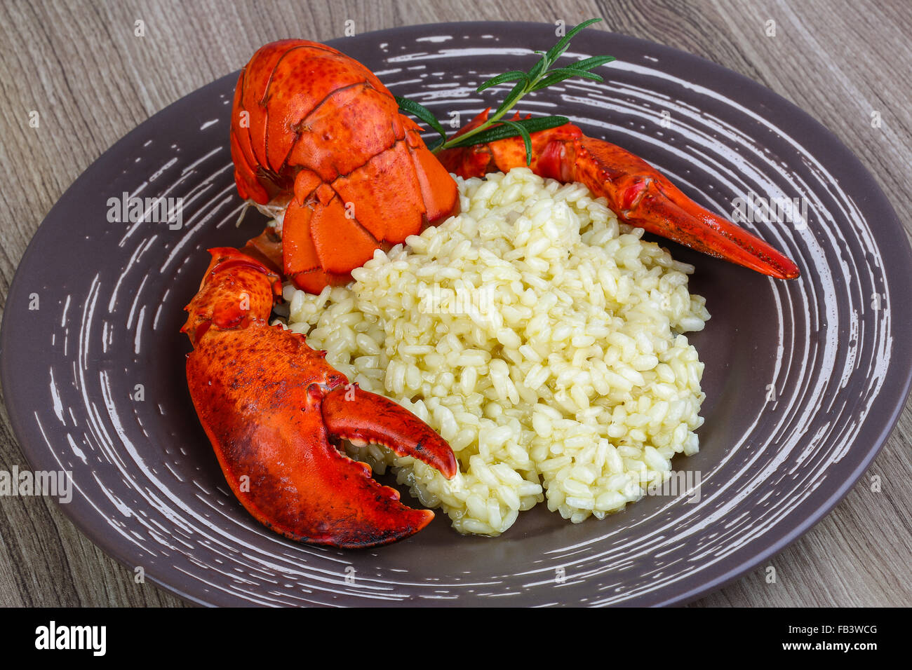 Delicous Risotto with lobster served rosemary and parmesan Stock Photo ...