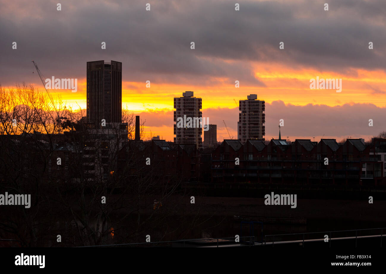 London, UK. 9th January, 2016. An orange and pink sunrise is seen from ...