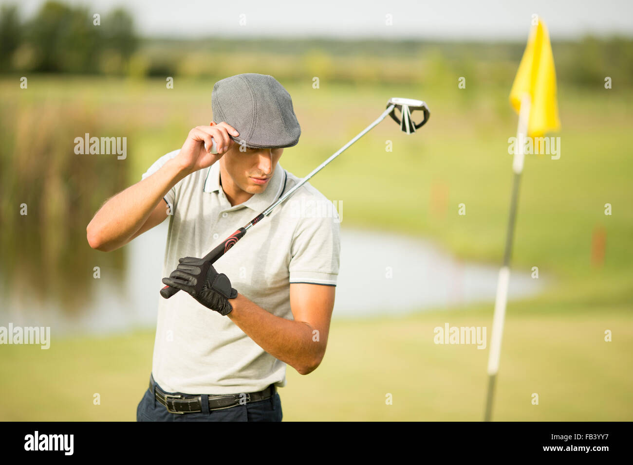 Young man playing golf Stock Photo - Alamy