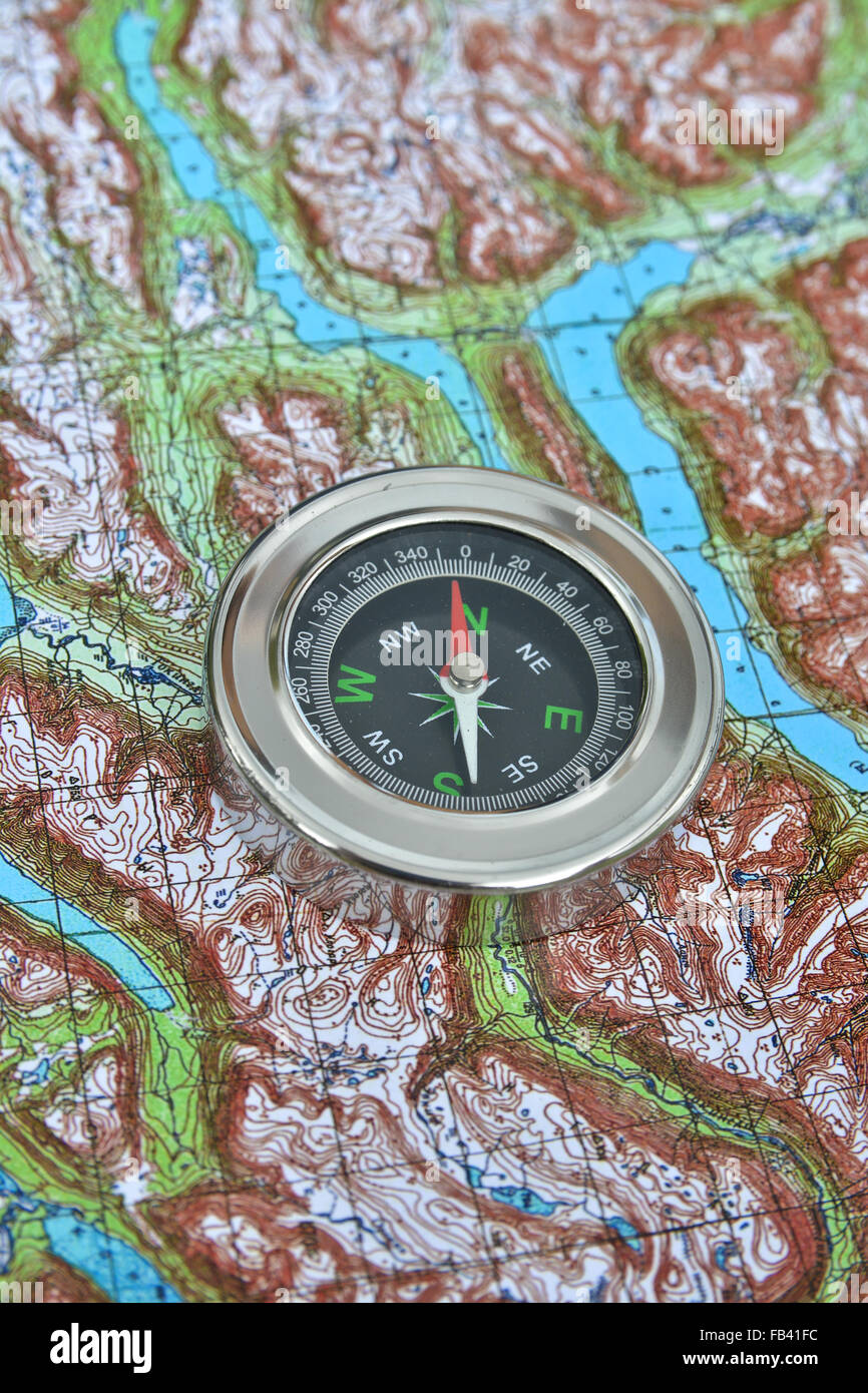 Map and compass. Magnetic compass is located on a topographic map Stock ...