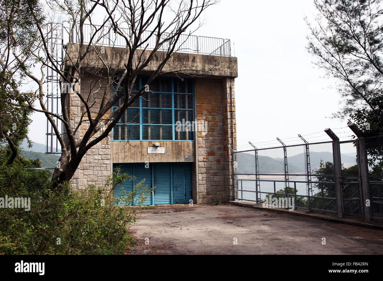 It's a photo of a small building near a water reservoir in Hong Kong ...