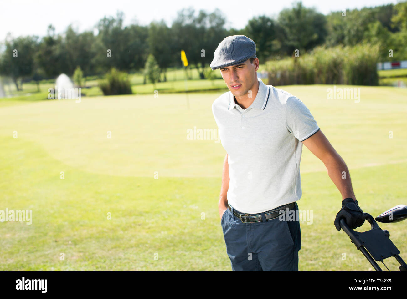 Young man playing golf Stock Photo - Alamy