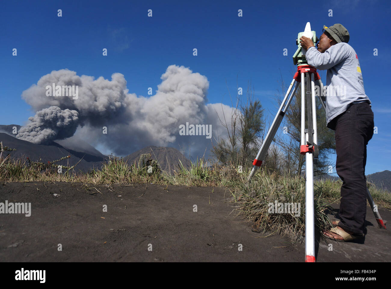 An observer of a volcano measures the deformation at Mount Bromo, using ...