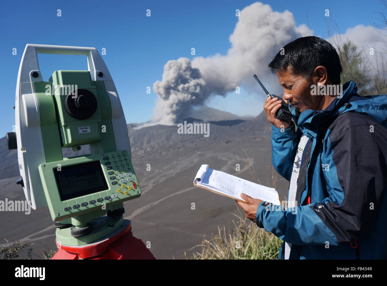 An observer of a volcano measures the deformation at Mount Bromo, using ...