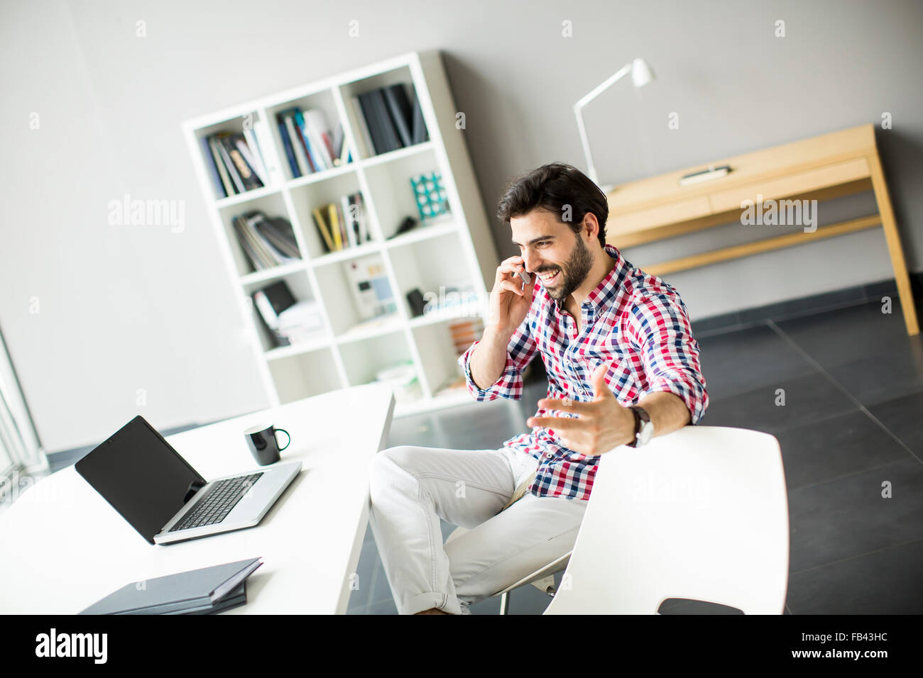 Young man at the office Stock Photo - Alamy