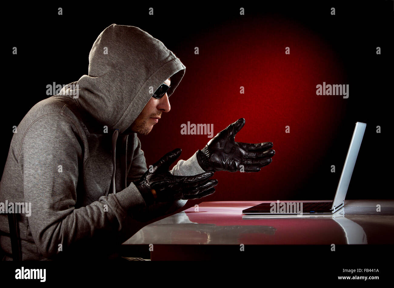 Hacker in a sunglasses with laptop Stock Photo - Alamy