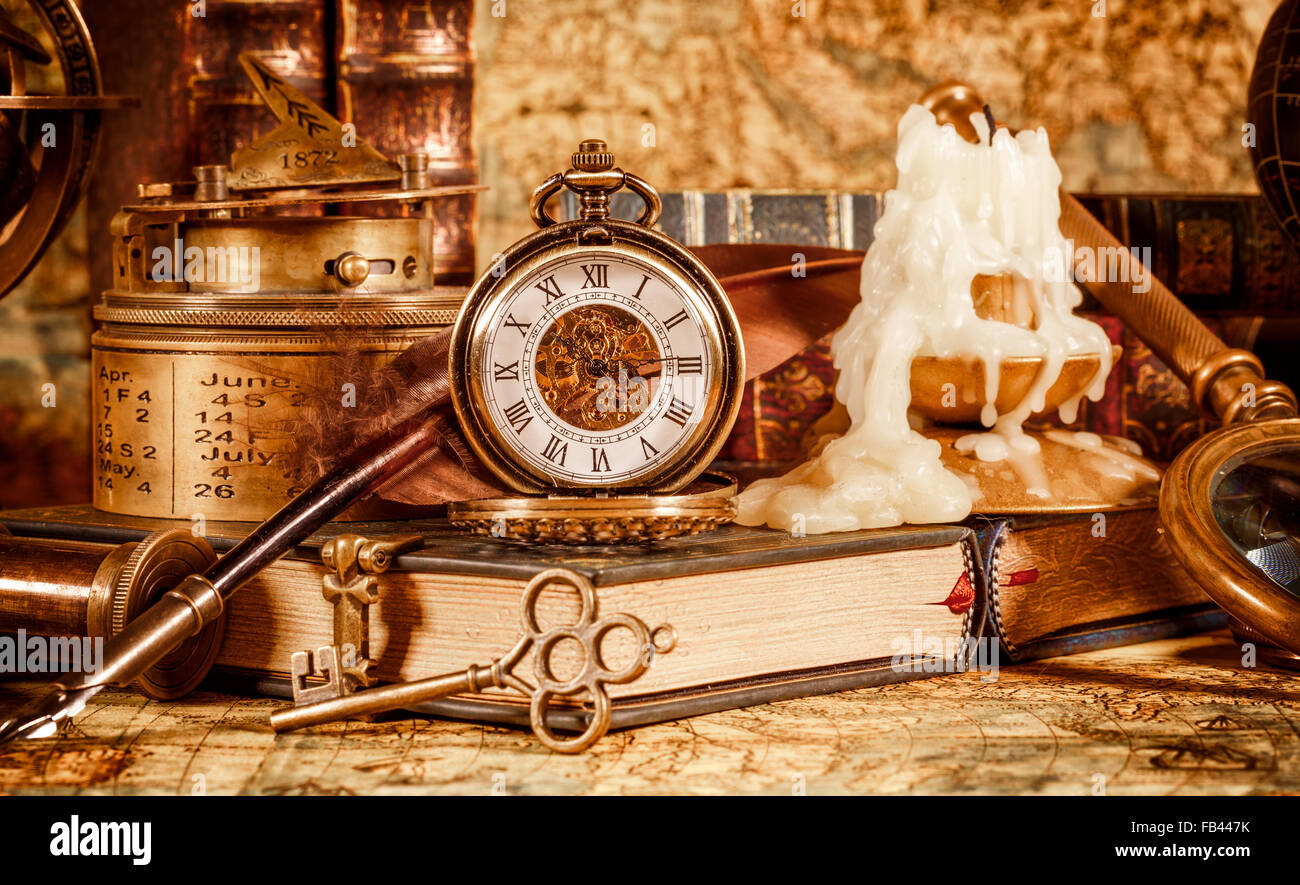 Vintage book, compass, telescope and a pocket watch lying on ancient ...