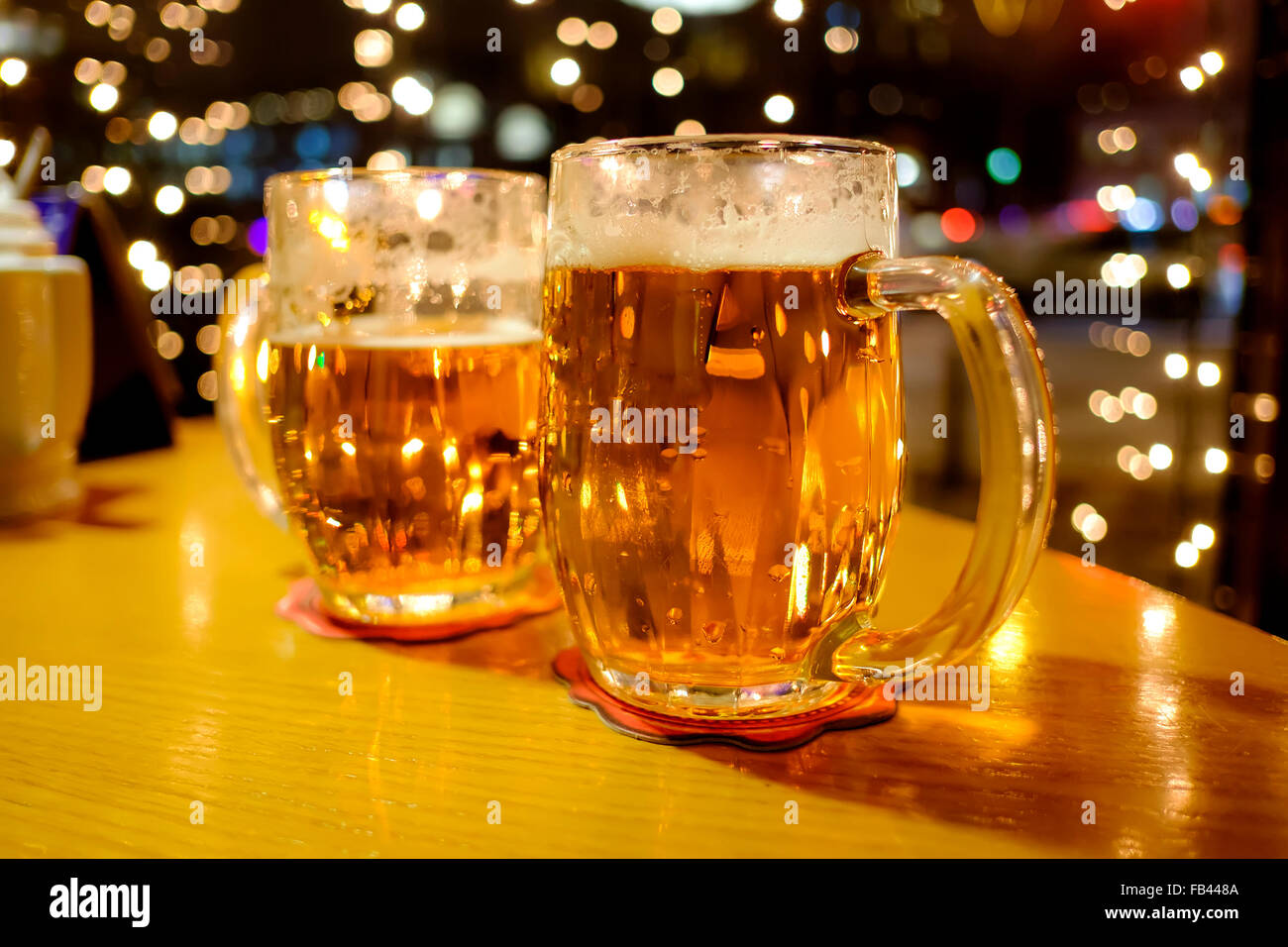 Two cups of beer in a pub Stock Photo - Alamy