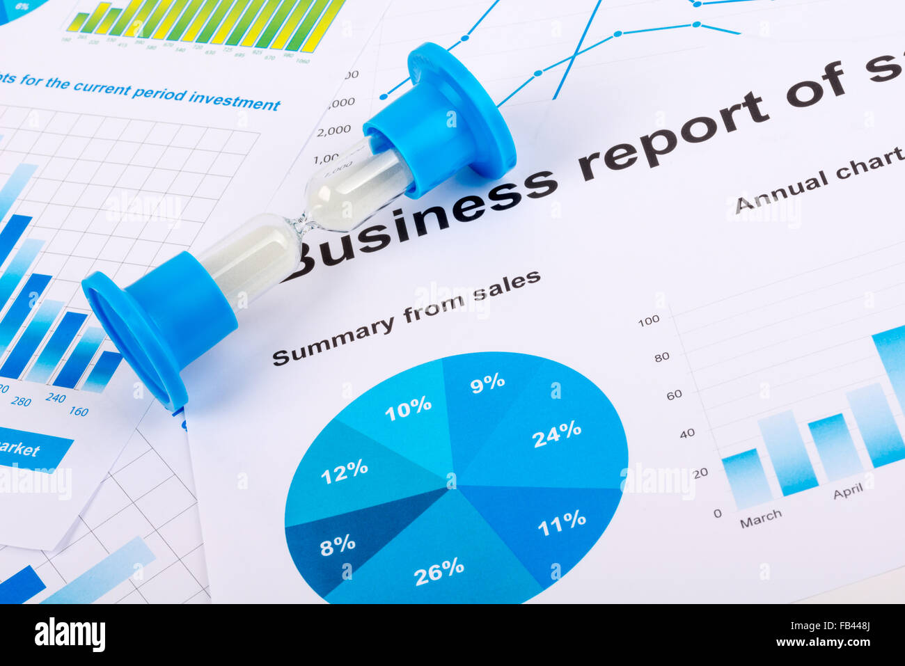 Financial charts and graphs. Sales report on paper. Hourglass. The ...