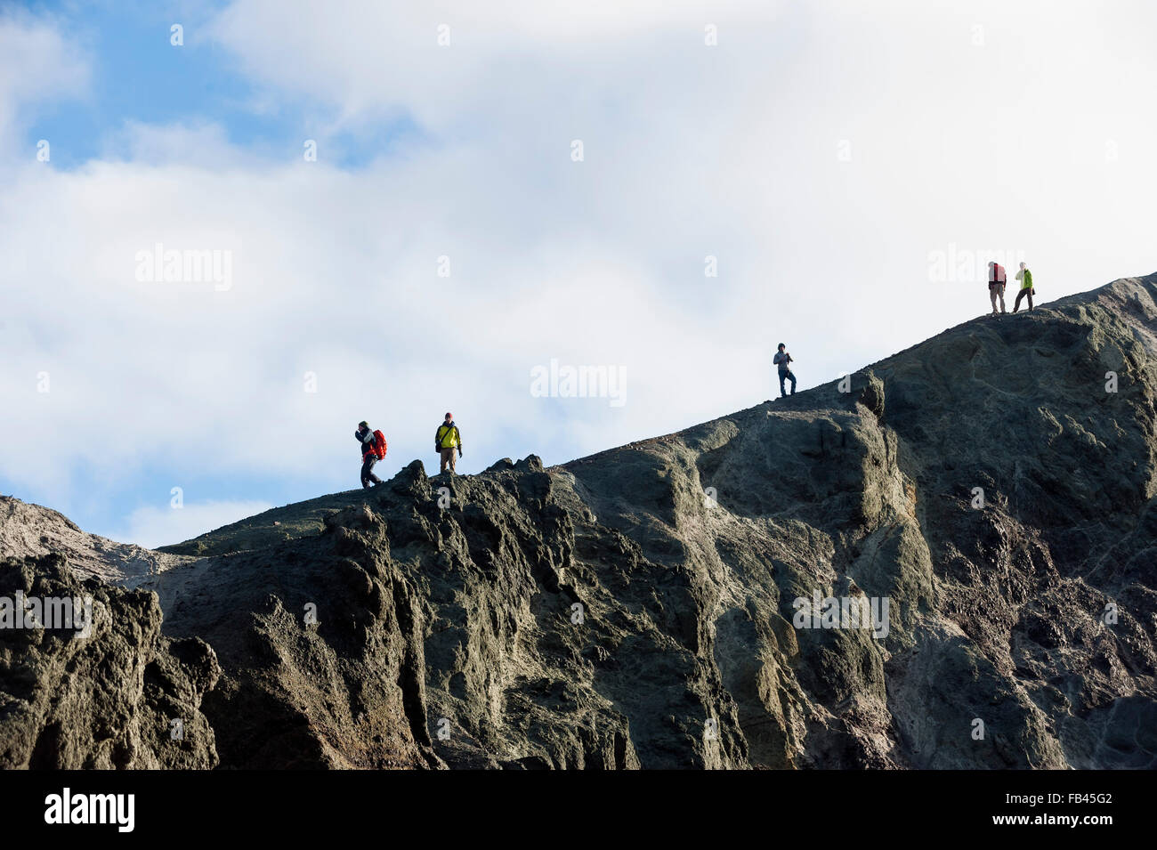 Climbing a mountain ridge Stock Photo - Alamy