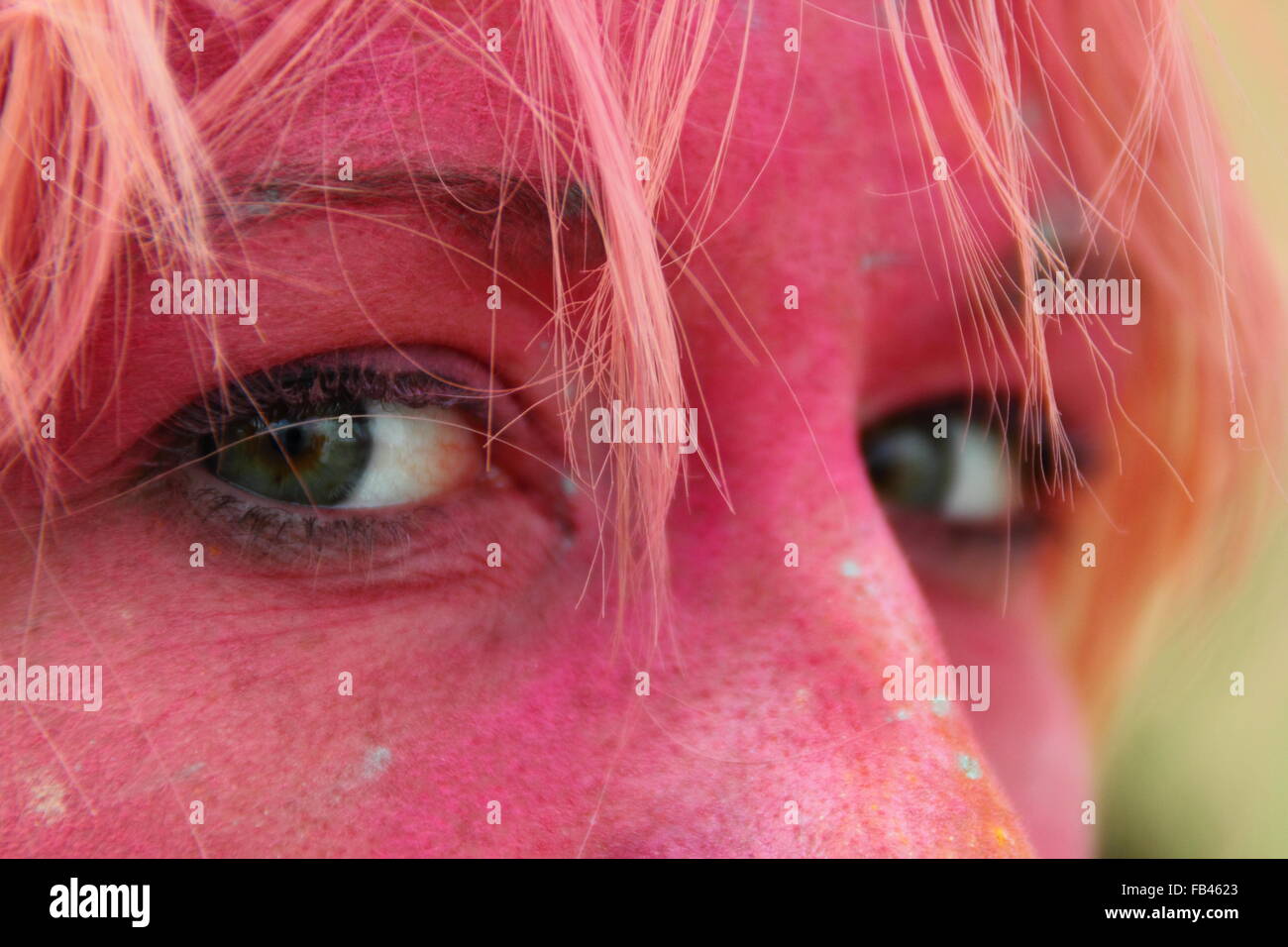 A young woman's face in powdered paint after joining other festival ...