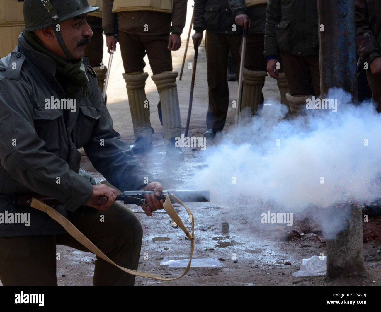 Srinagar, Kashmir. 9th January, 2016. An Indian police officer fire ...