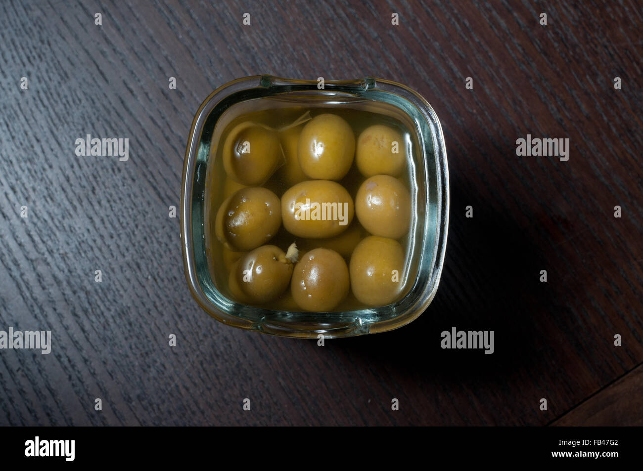 an open jar of stuffed Olives on a table Stock Photo - Alamy