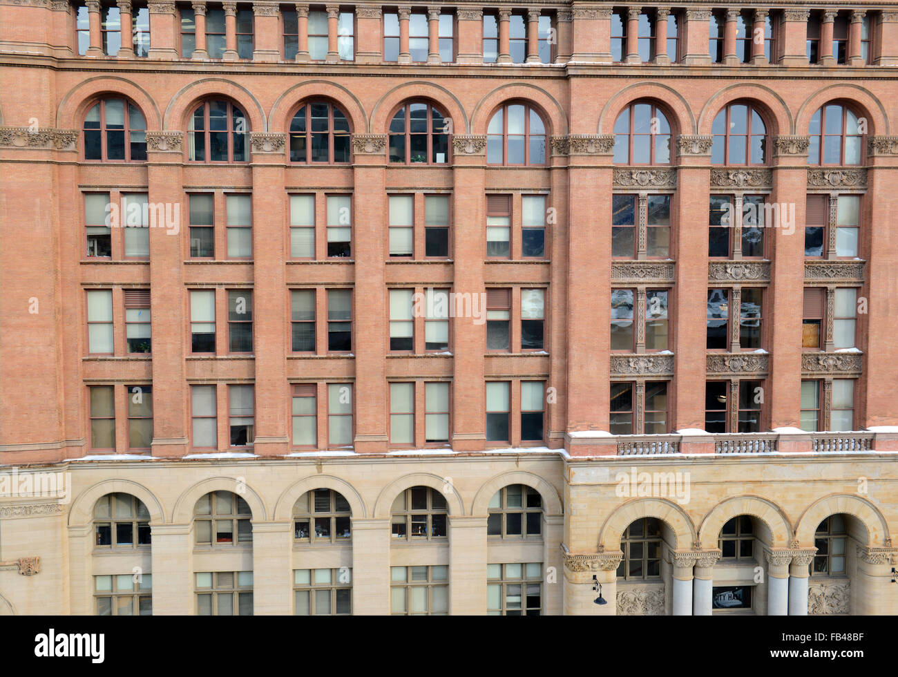 Facade of brick vintage building with arches and windows Stock Photo ...