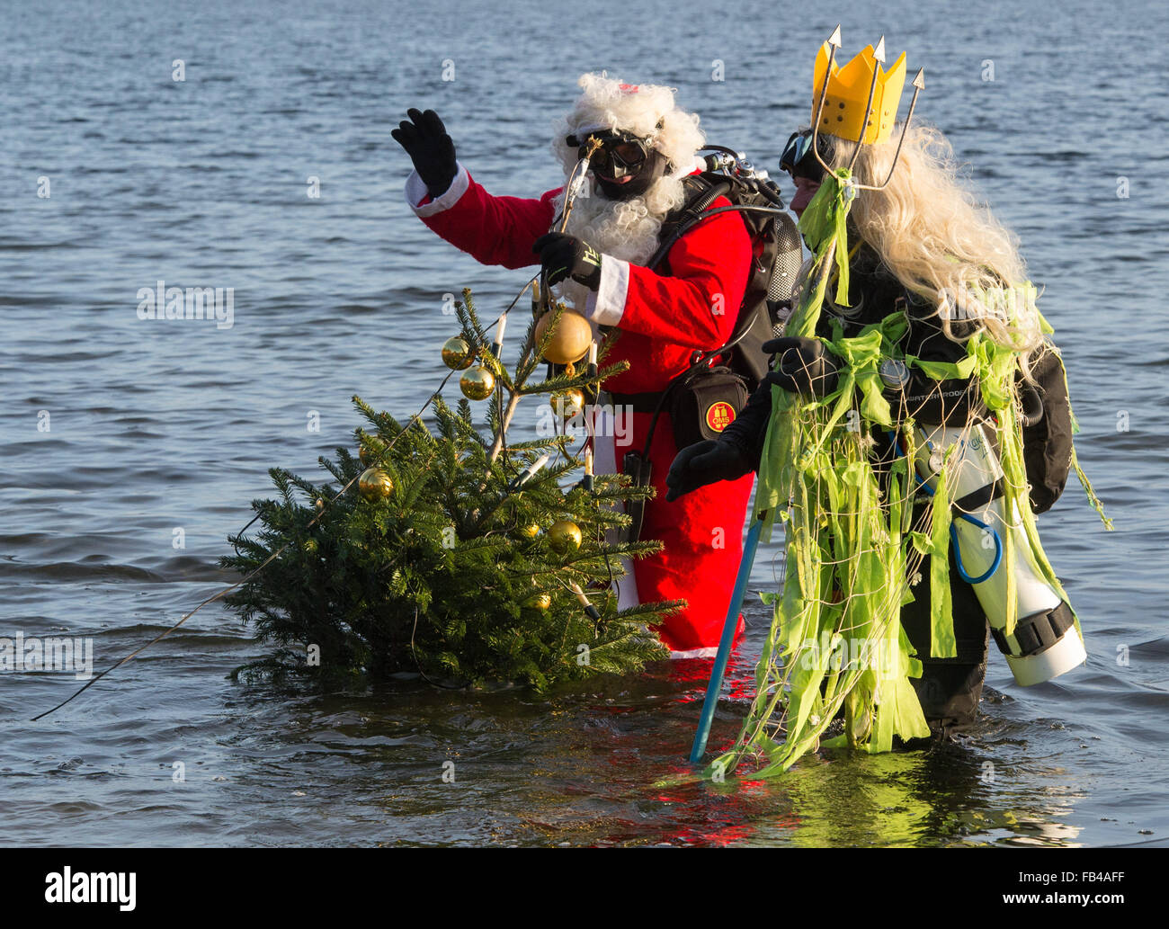 Two divers dressed as Neptune and Santa Claus with a decorated ...