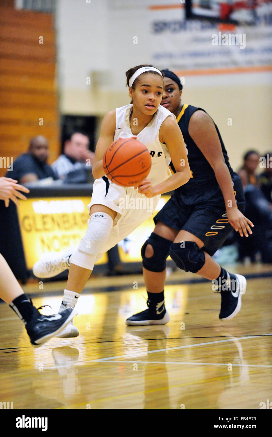 High school guard kniving her way toward the basket and past a ...