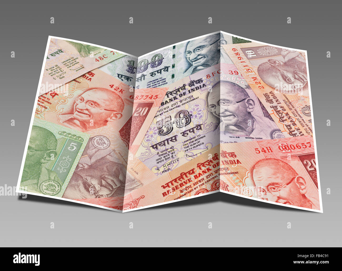 Many Indian rupees bills with the portrait of Mahatma Gandhi lying side ...