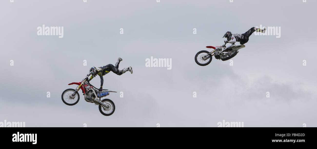 Motorcycle display team Bold Dog, two riders in midair during a stunt ...