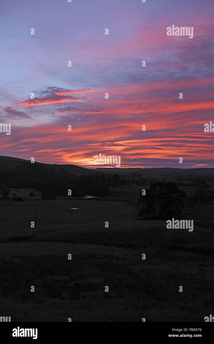 Red sunrise over the North Tyne valley, Northumberland, England, UK ...