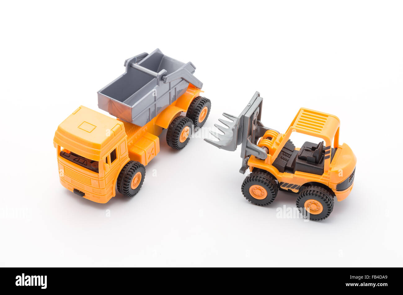 Two orange toy construction vehicles on plan drawing background Stock ...