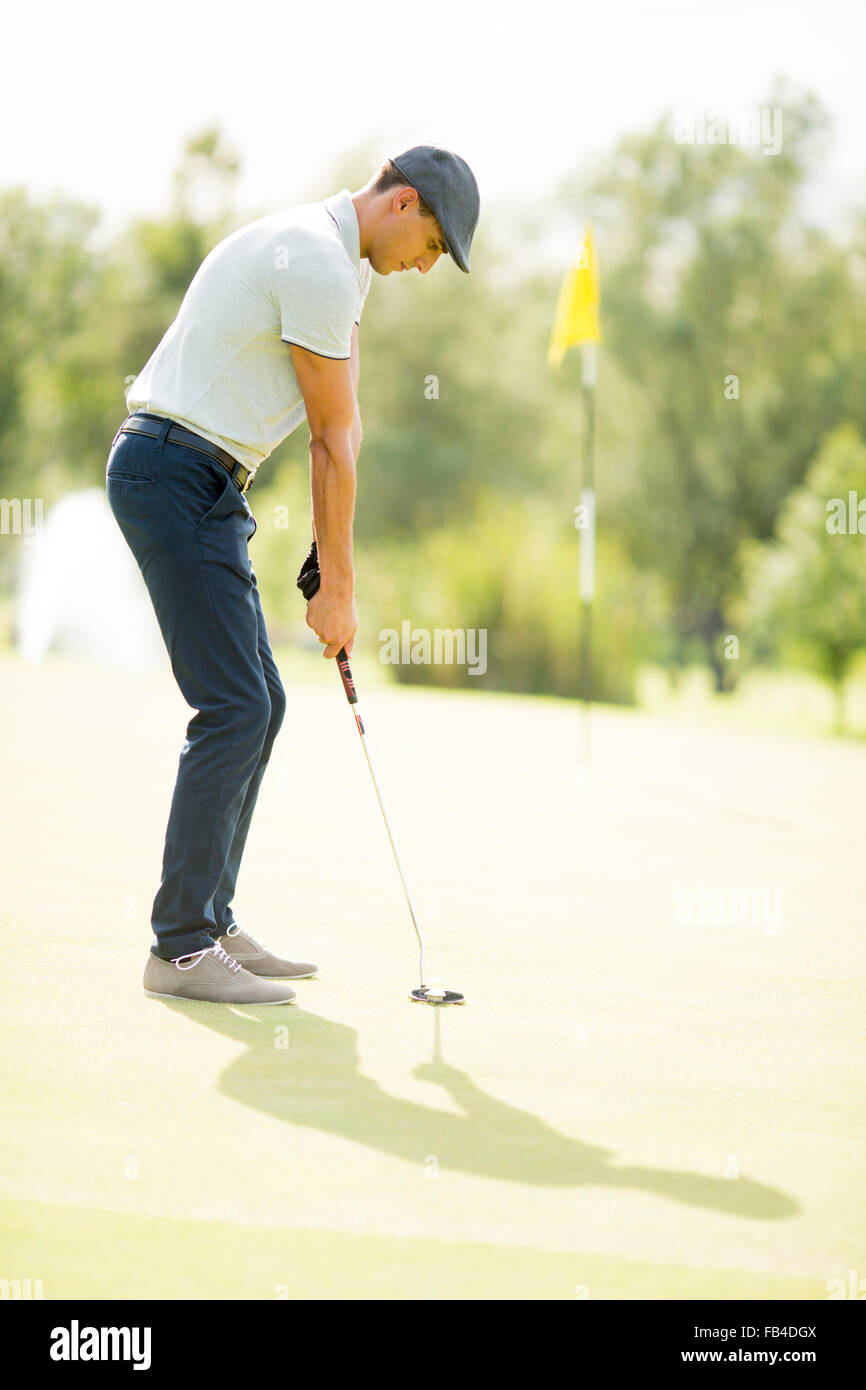 Young man playing golf Stock Photo - Alamy