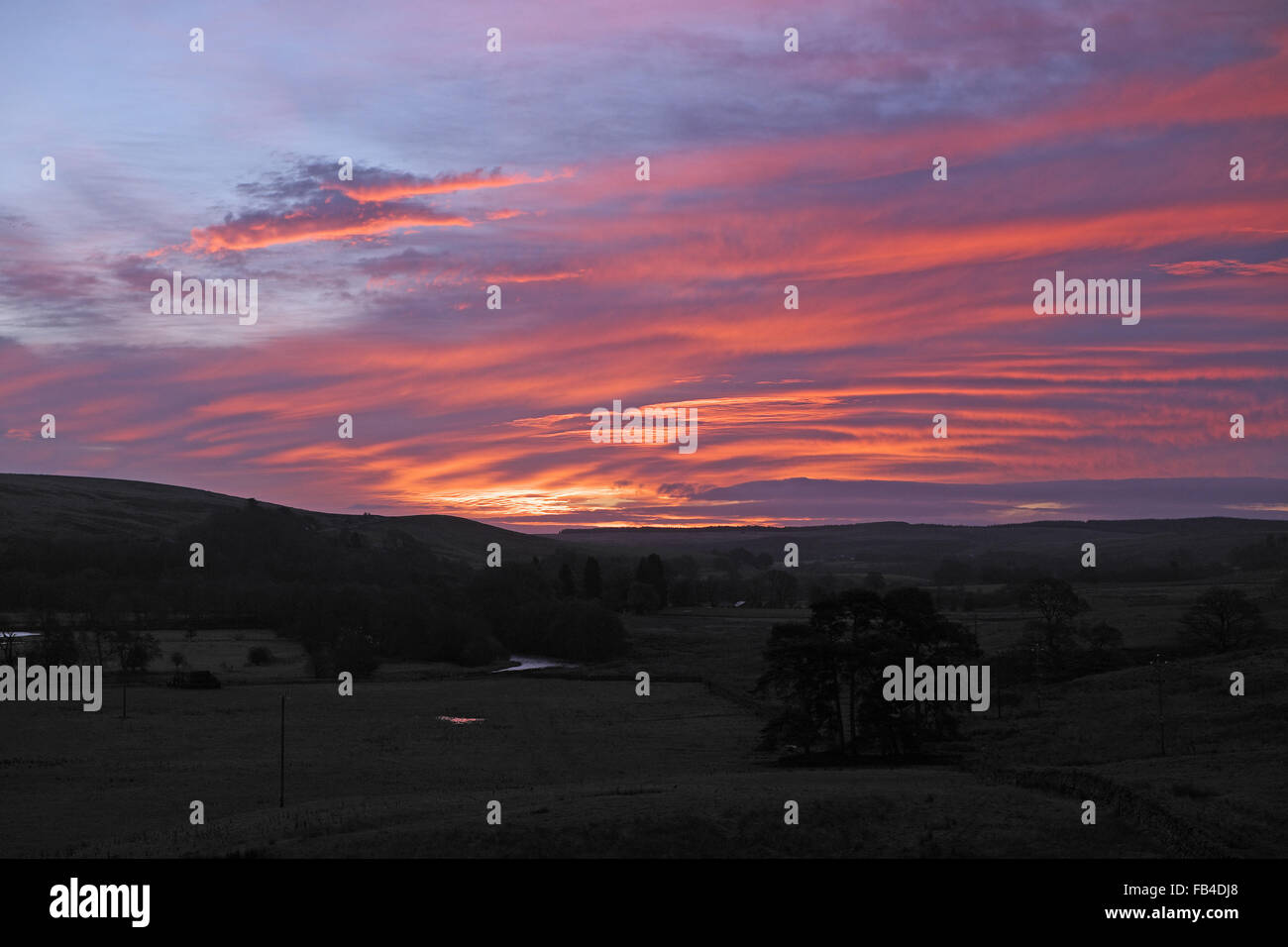 Red sunrise over the North Tyne valley, Northumberland, England, UK ...