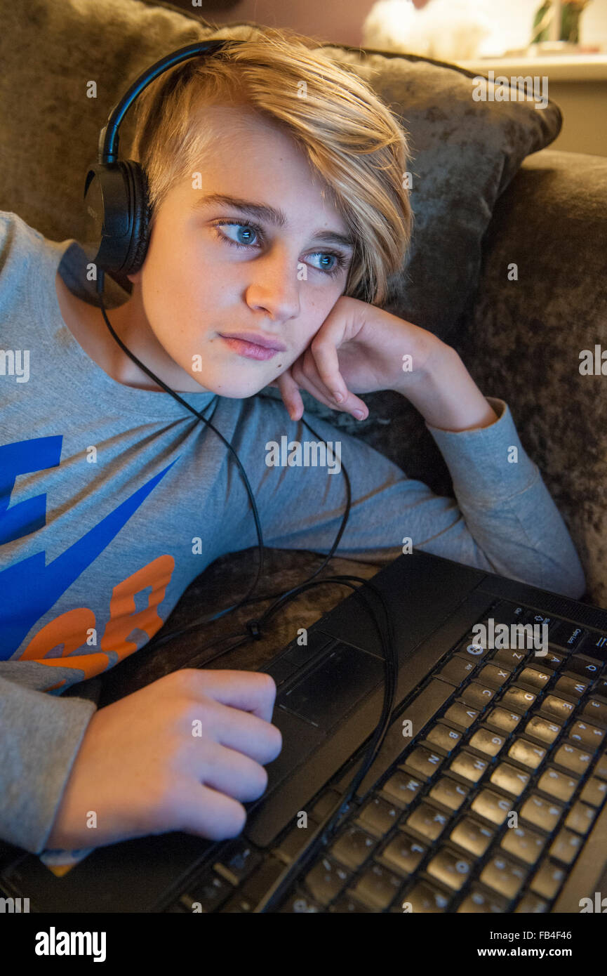 A young boy plays on his laptop computer Stock Photo - Alamy