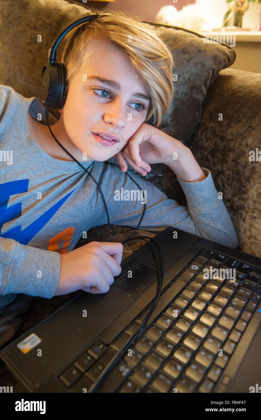 A young boy plays on his laptop computer Stock Photo - Alamy
