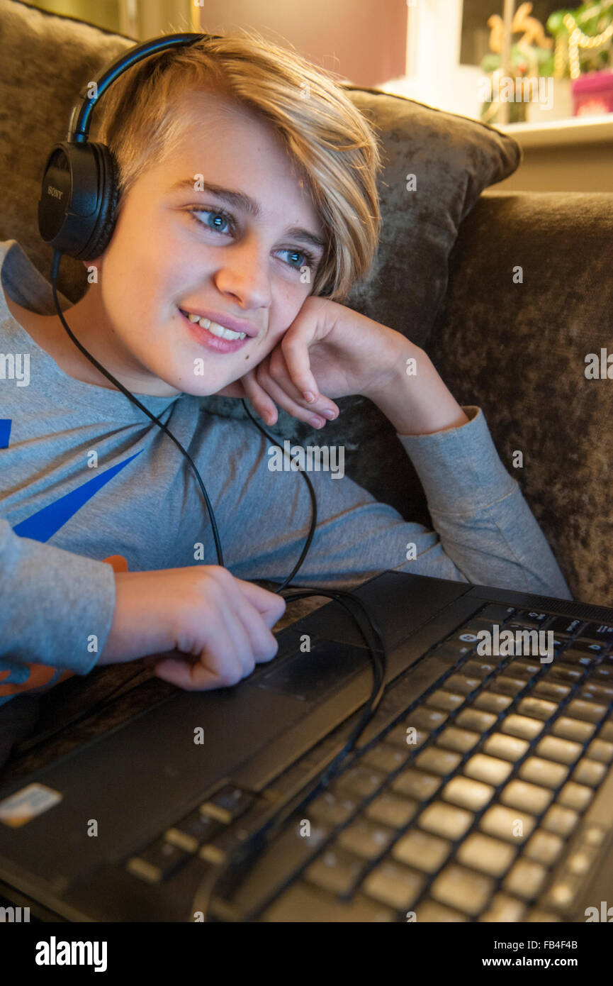 A young boy plays on his laptop computer Stock Photo - Alamy