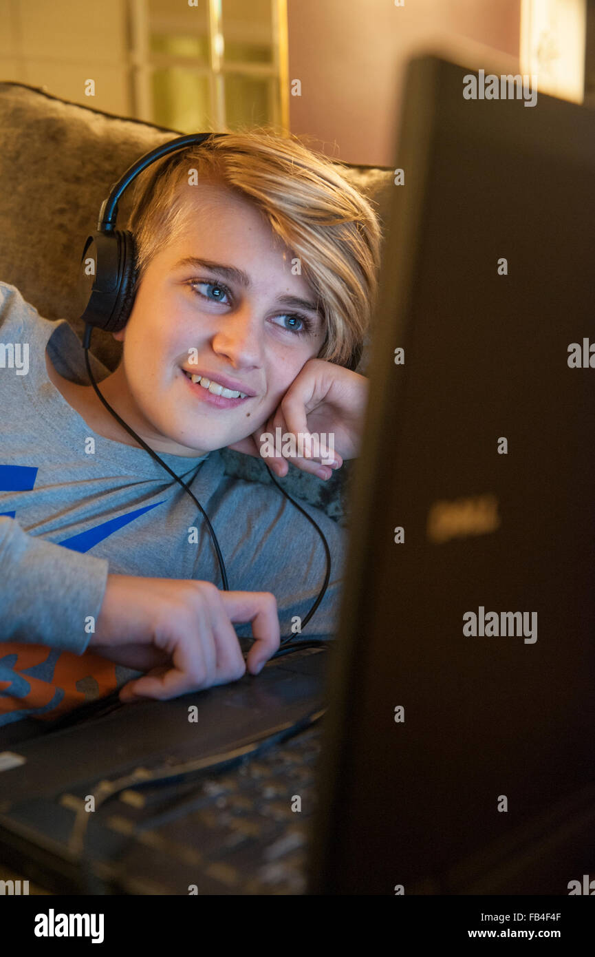 A young boy plays on his laptop computer Stock Photo - Alamy